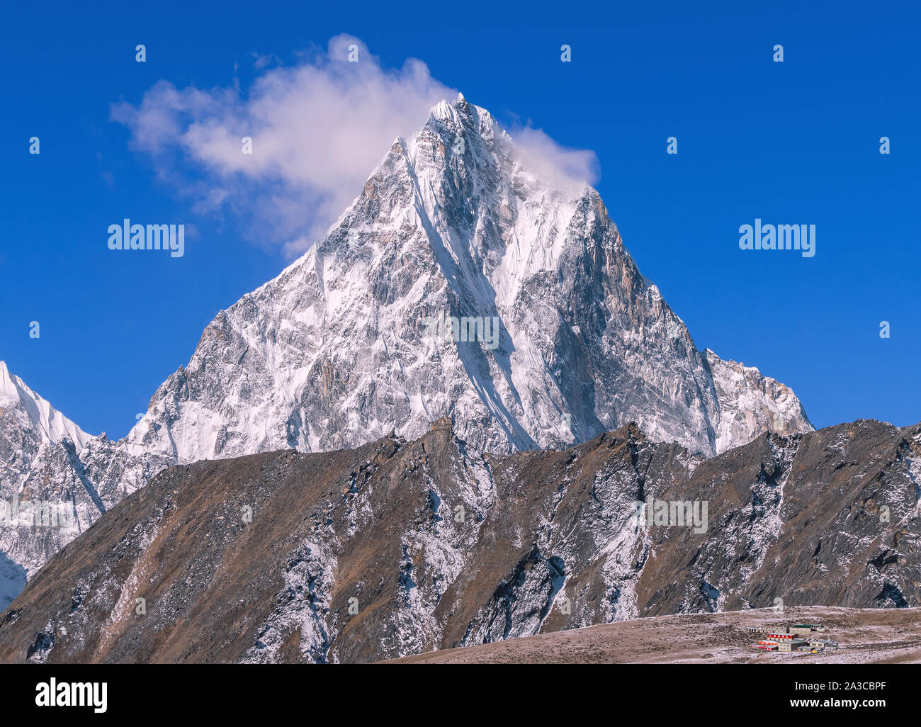 Mountain huts at the foot of majestic Cholatse peak (6,501m) at sunrise ...
