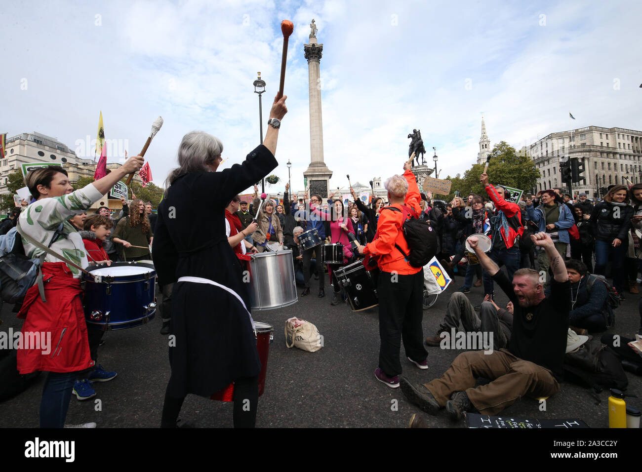 People playing drums block the road during the Extinction Rebellion ...