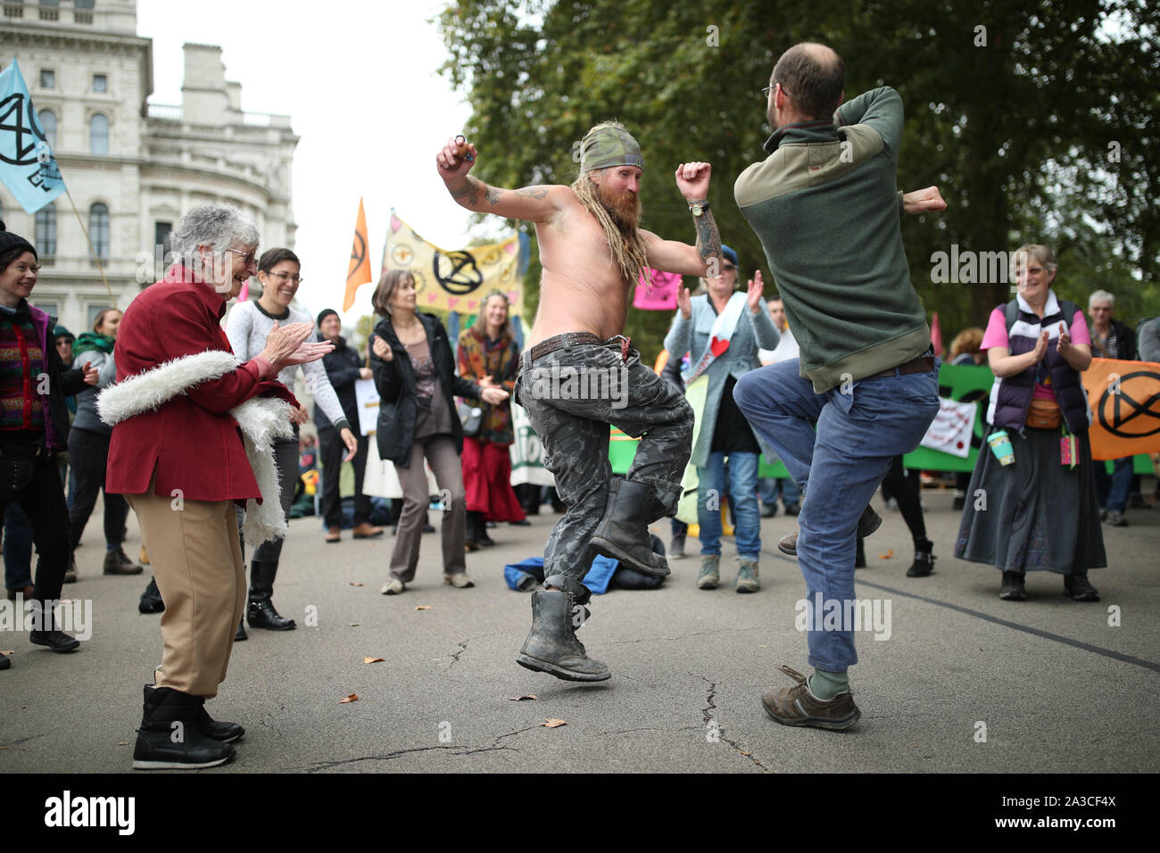 Protesters dance during an Extinction Rebellion (XR) protest in ...