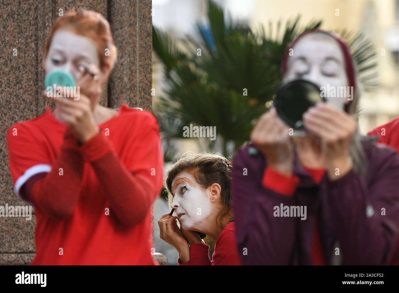 Members of "The Red Brigade" get into costume and apply make-up for an ...