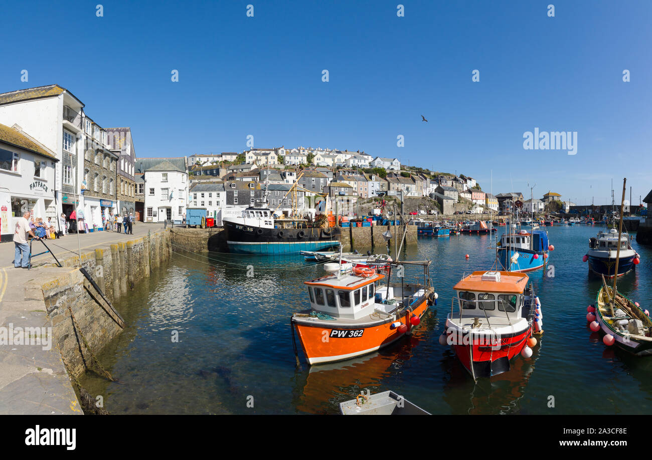 Mevagissey harbour with boats at anchor the village is within the ...