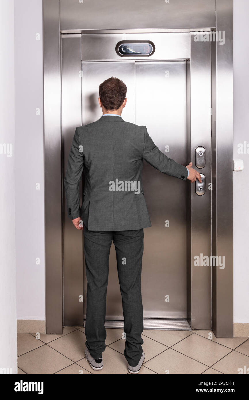 Businessman calling lift hi-res stock photography and images - Alamy