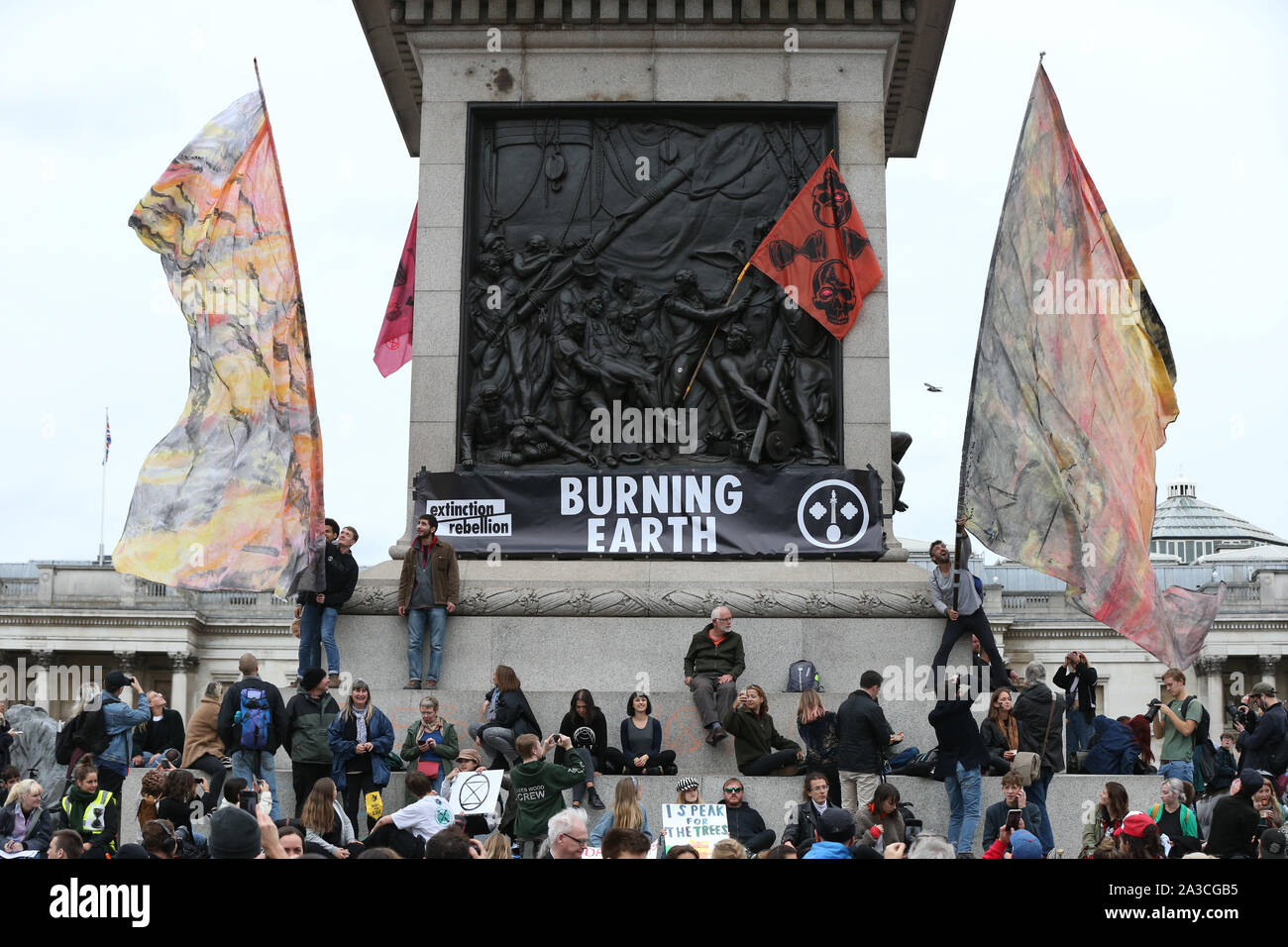Protesters climb the monuments at the Extinction Rebellion (XR) protest ...