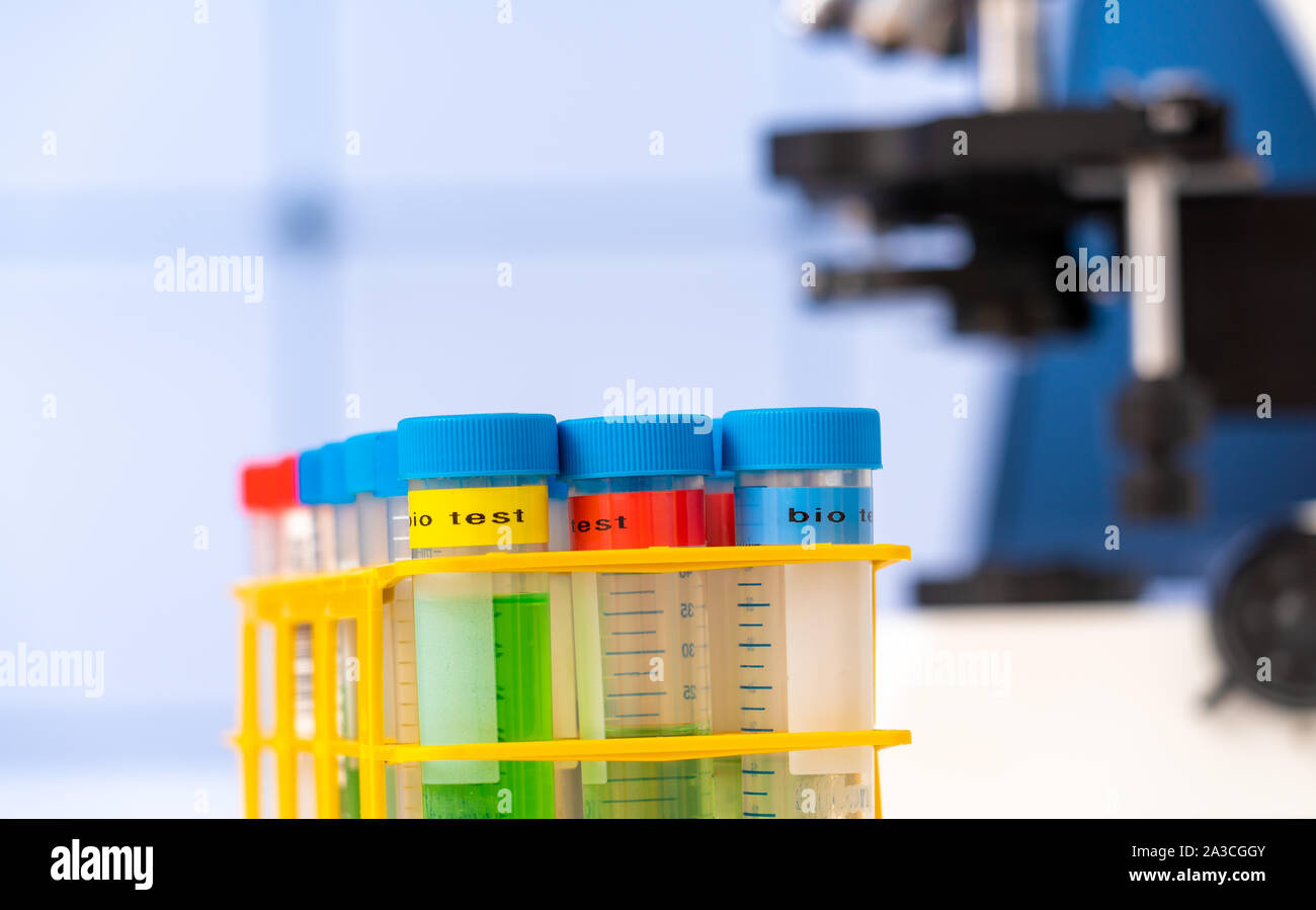 Scientific experiment in microbiological lab. Microscope and test tube ...
