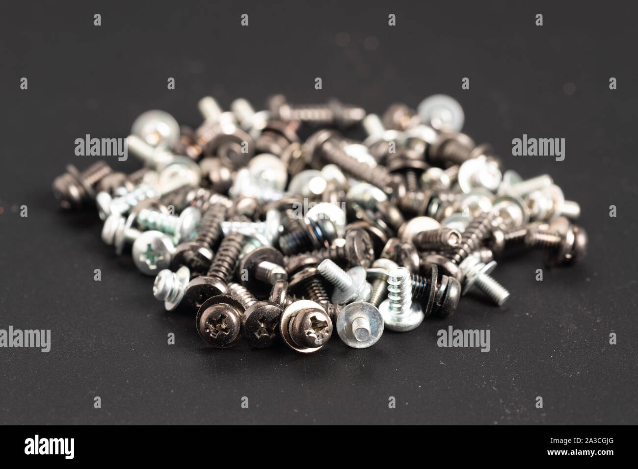Screws and bolts fasteners industrial black background Stock Photo - Alamy