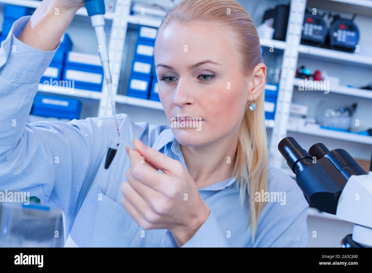 Female technician in laboratory of genetics - reprogenetics. Young ...