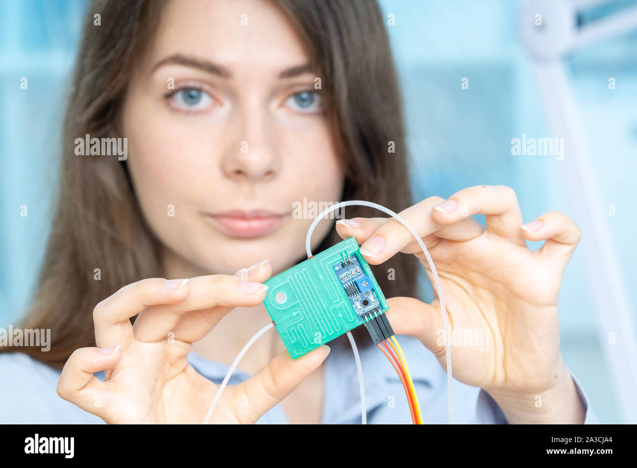 Young scientist woman in microbiological lab with lab-on-chip LOC ...