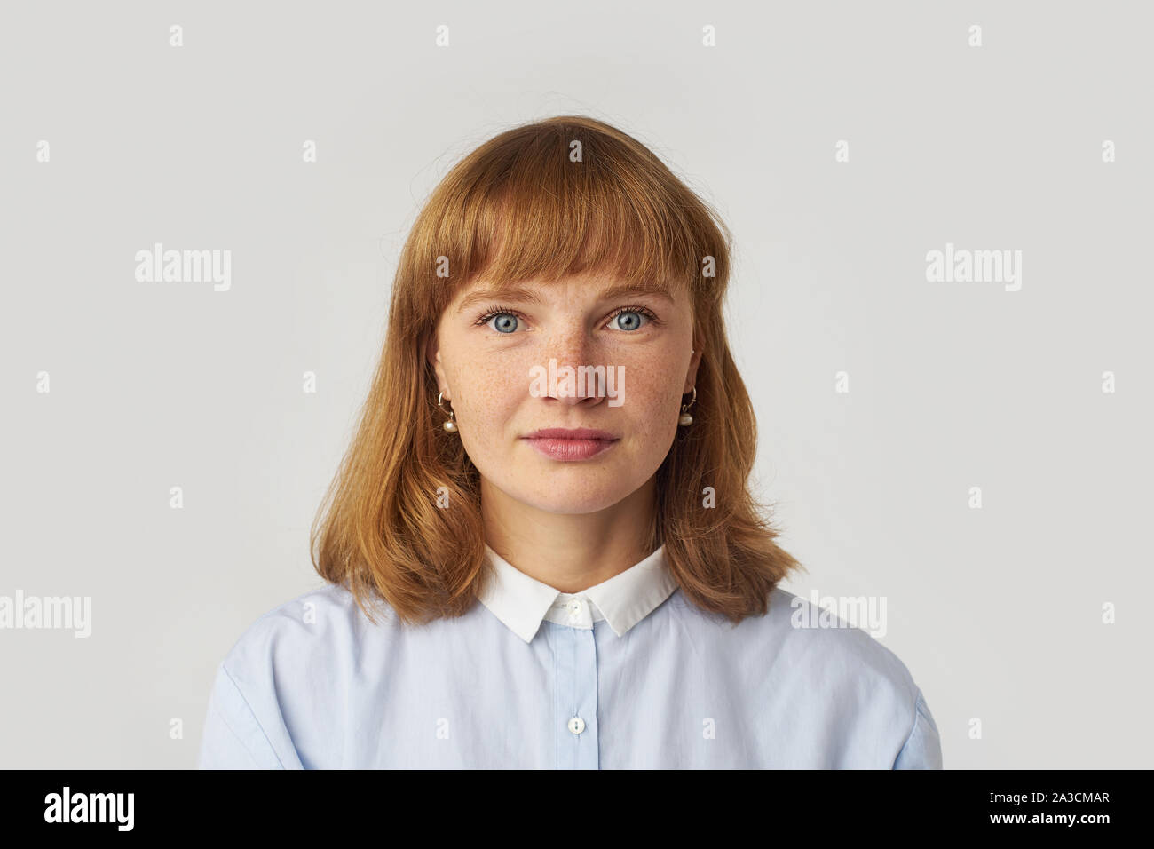Headshot of young female model with ginger hair and freckles dressed in ...