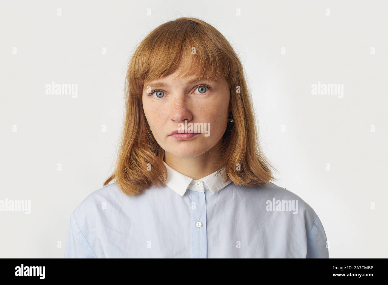 Headshot of young female model with ginger hair and freckles dressed in ...