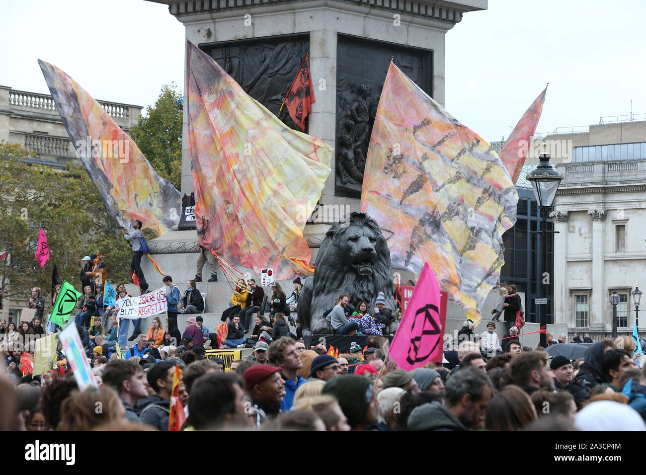 Protesters climb the monuments at the Extinction Rebellion (XR) protest ...