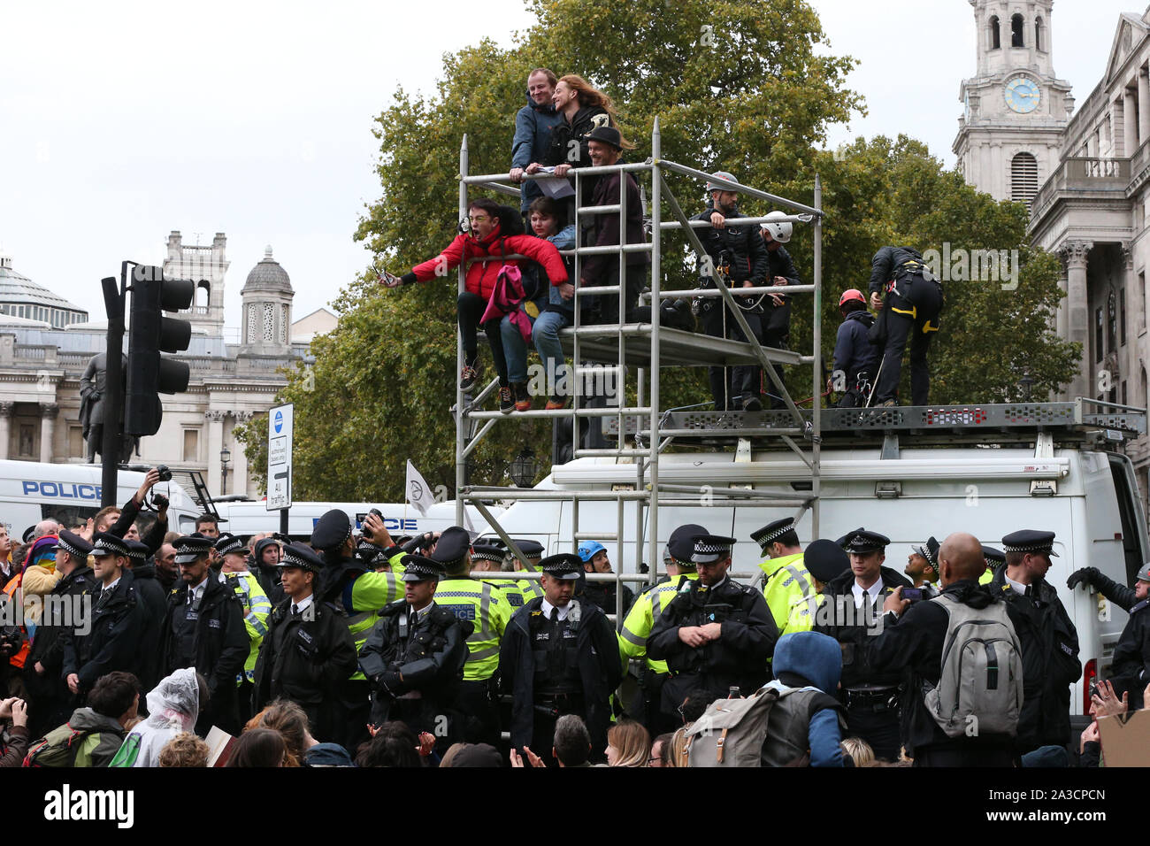 Police wearing abseiling safety equipment arrive to remove protesters ...