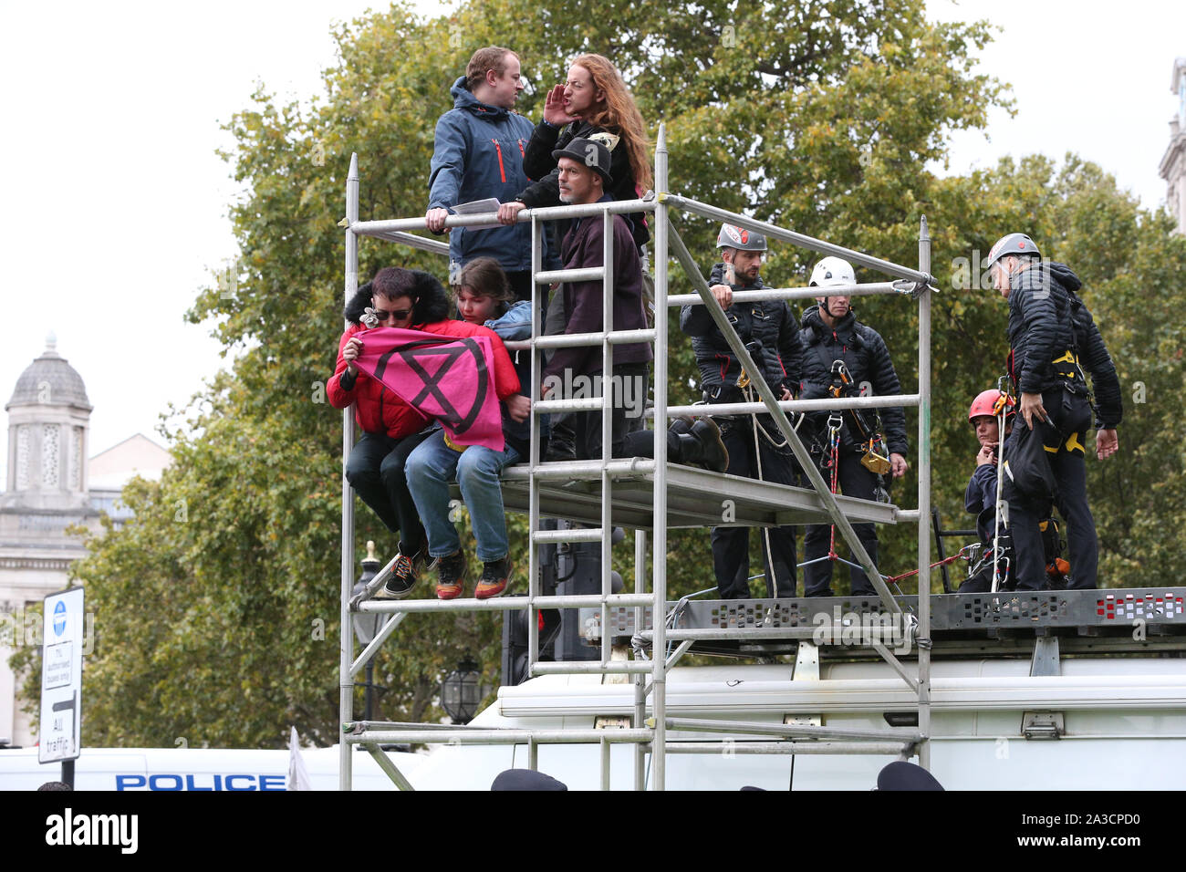 Police wearing abseiling safety equipment arrive to remove protesters ...