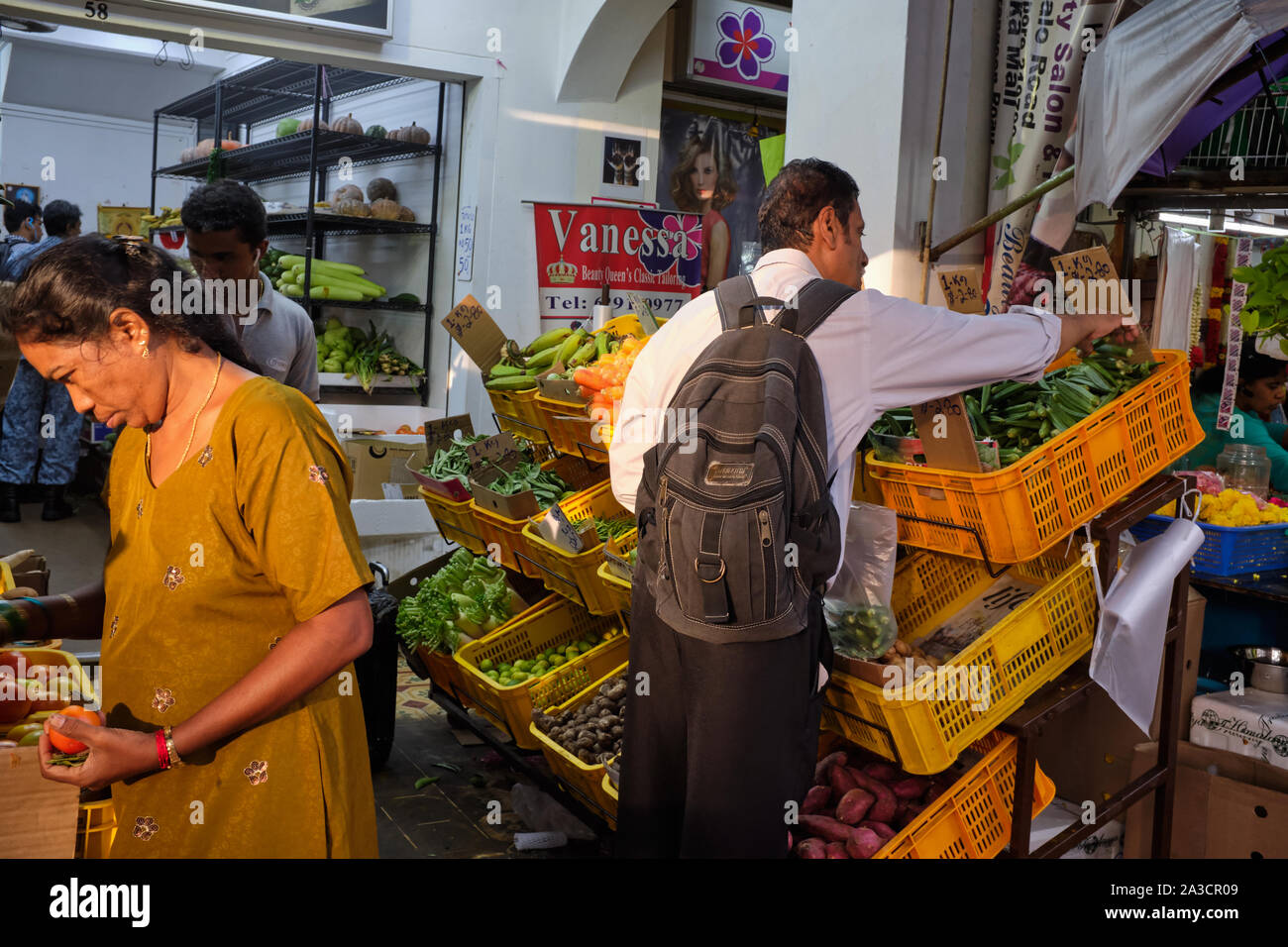 Indian shoppers selecting goods at an inexpensive Indian fruit and ...