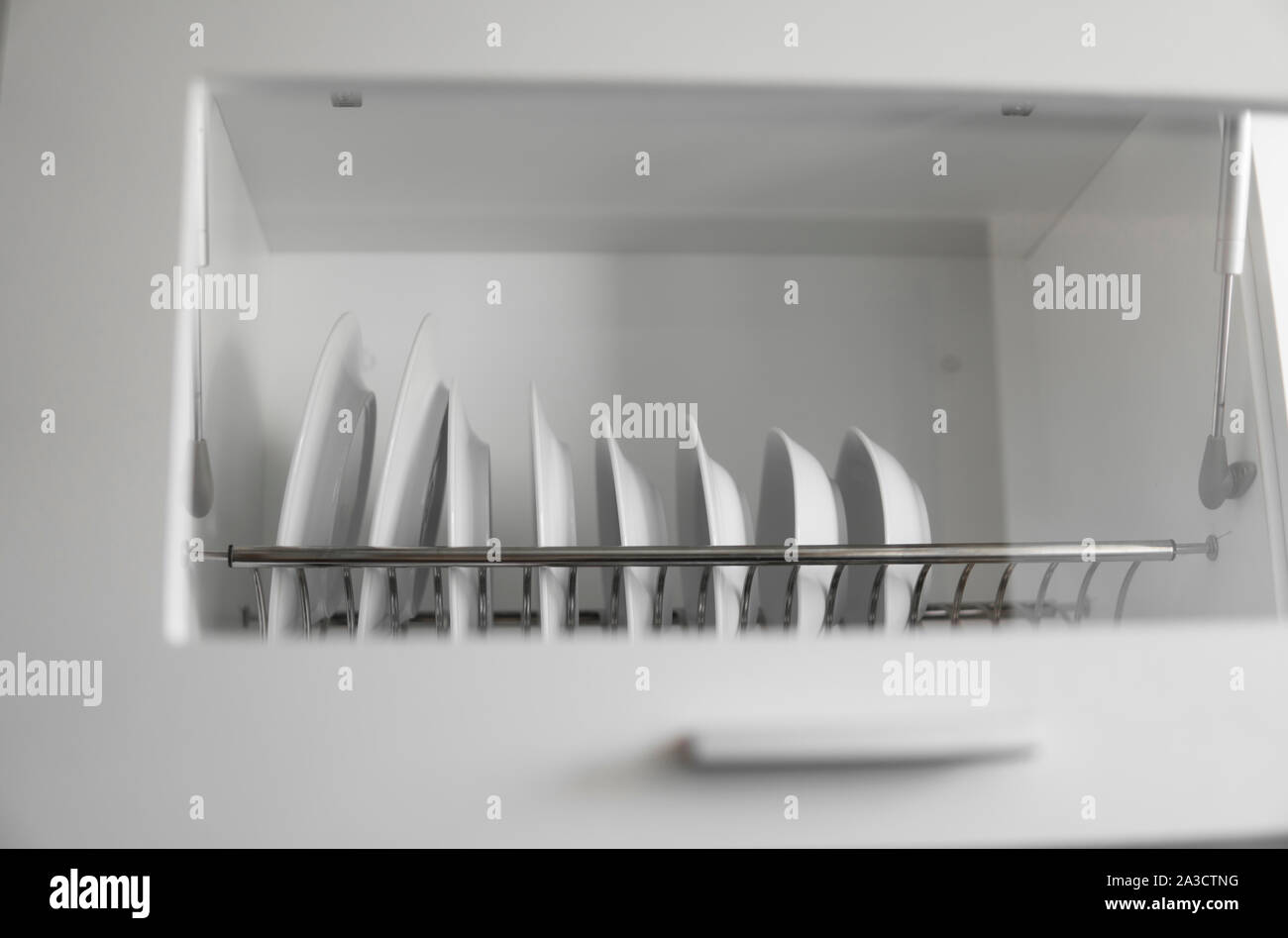 Dish drying metal rack with big nice white clean plates. Traditional ...