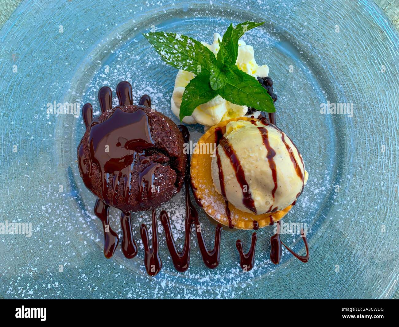 Chocolate Souffle Dessert with Ice Cream and Mint Blade on Plate in ...