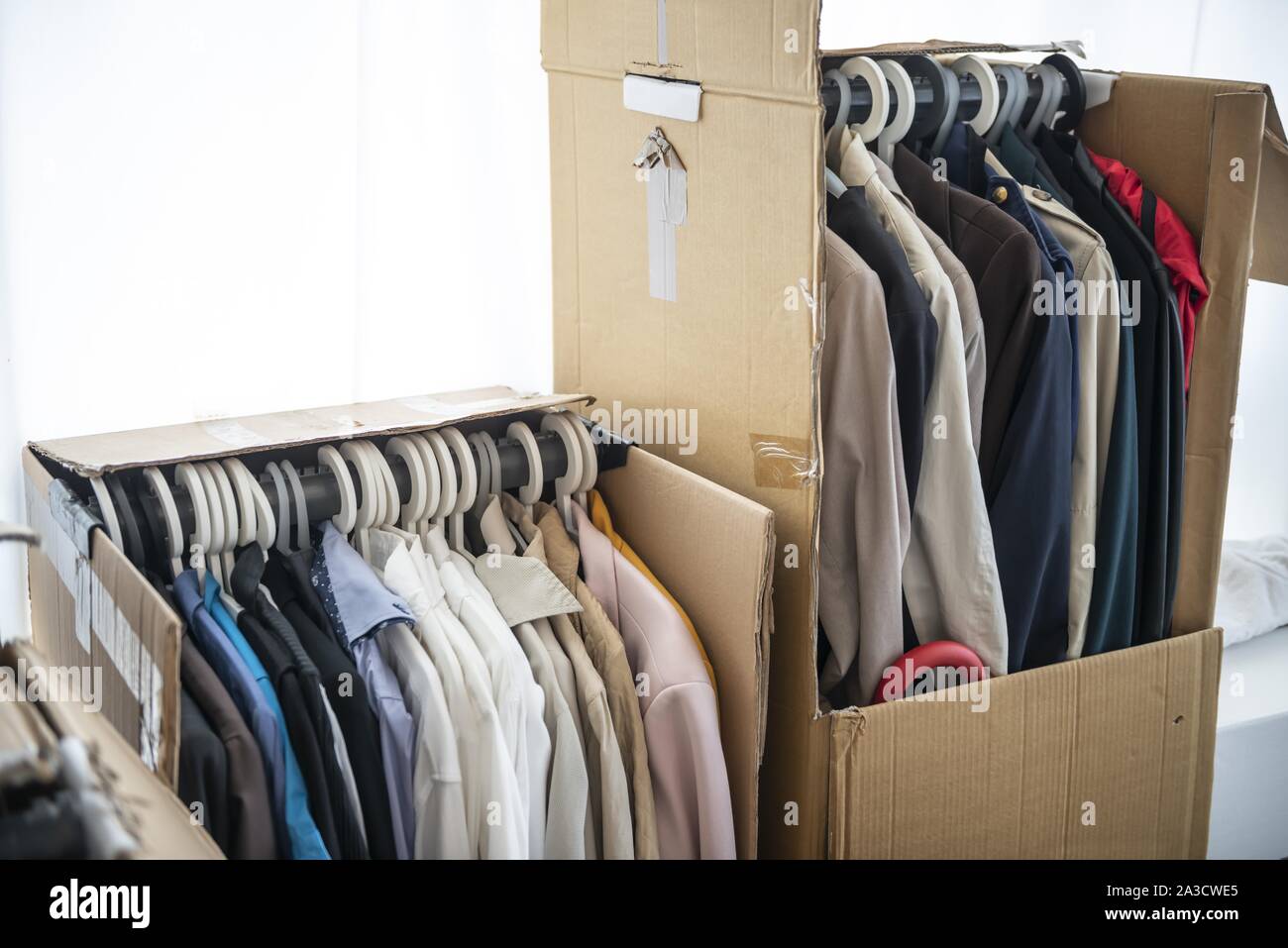 Clothes in Cardboard Boxes Stock Photo - Alamy