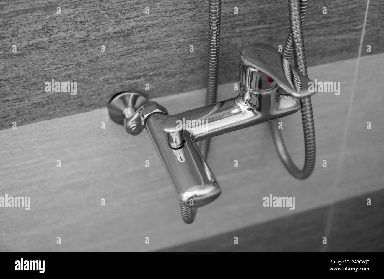 Modern designer tap and shower in bathroom. Closeup of chrome shower ...