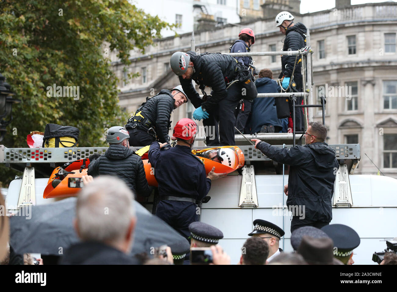 Police wearing abseiling safety equipment arrive to remove protesters ...