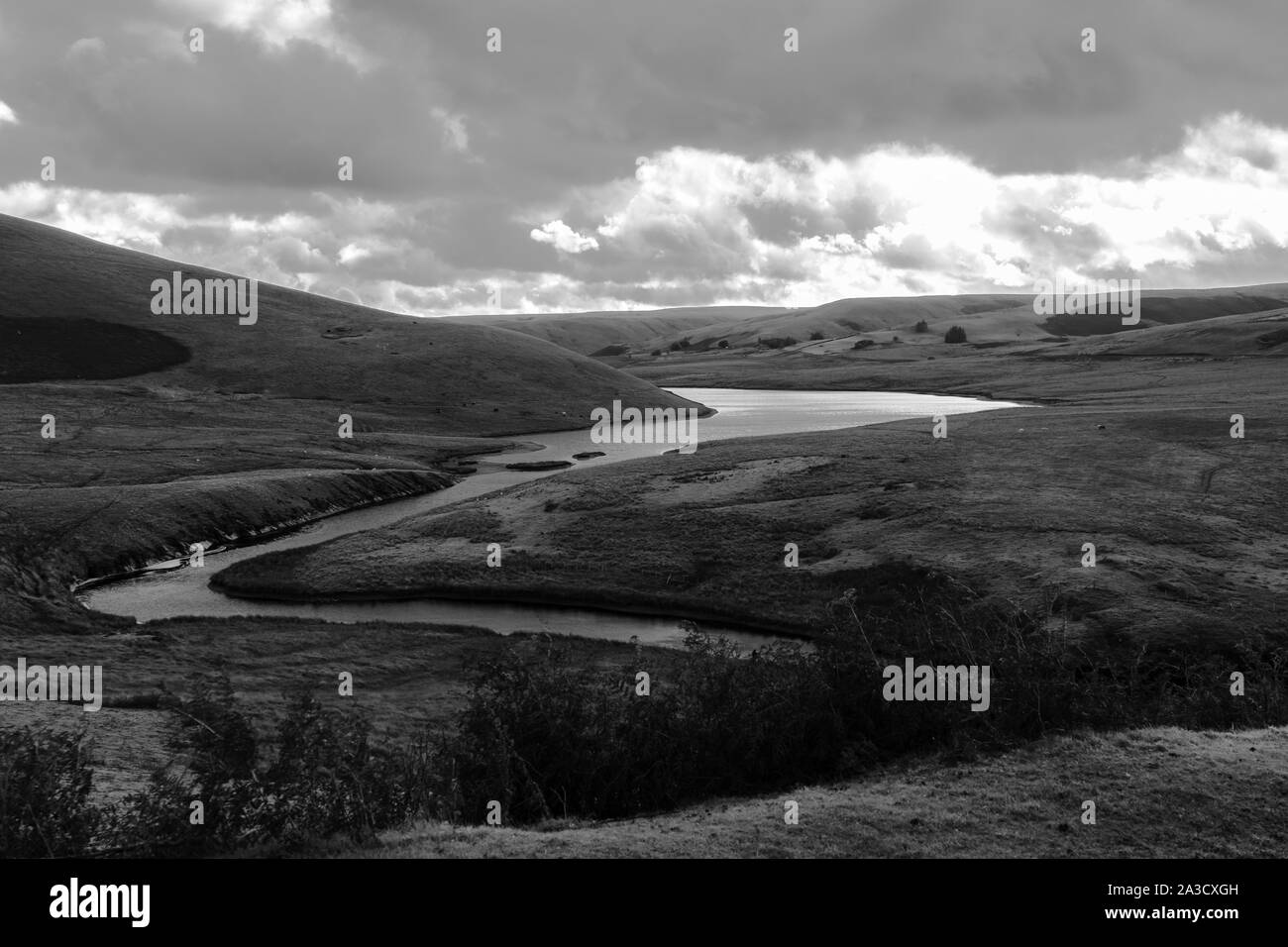 black and white river runs though valley Stock Photo - Alamy