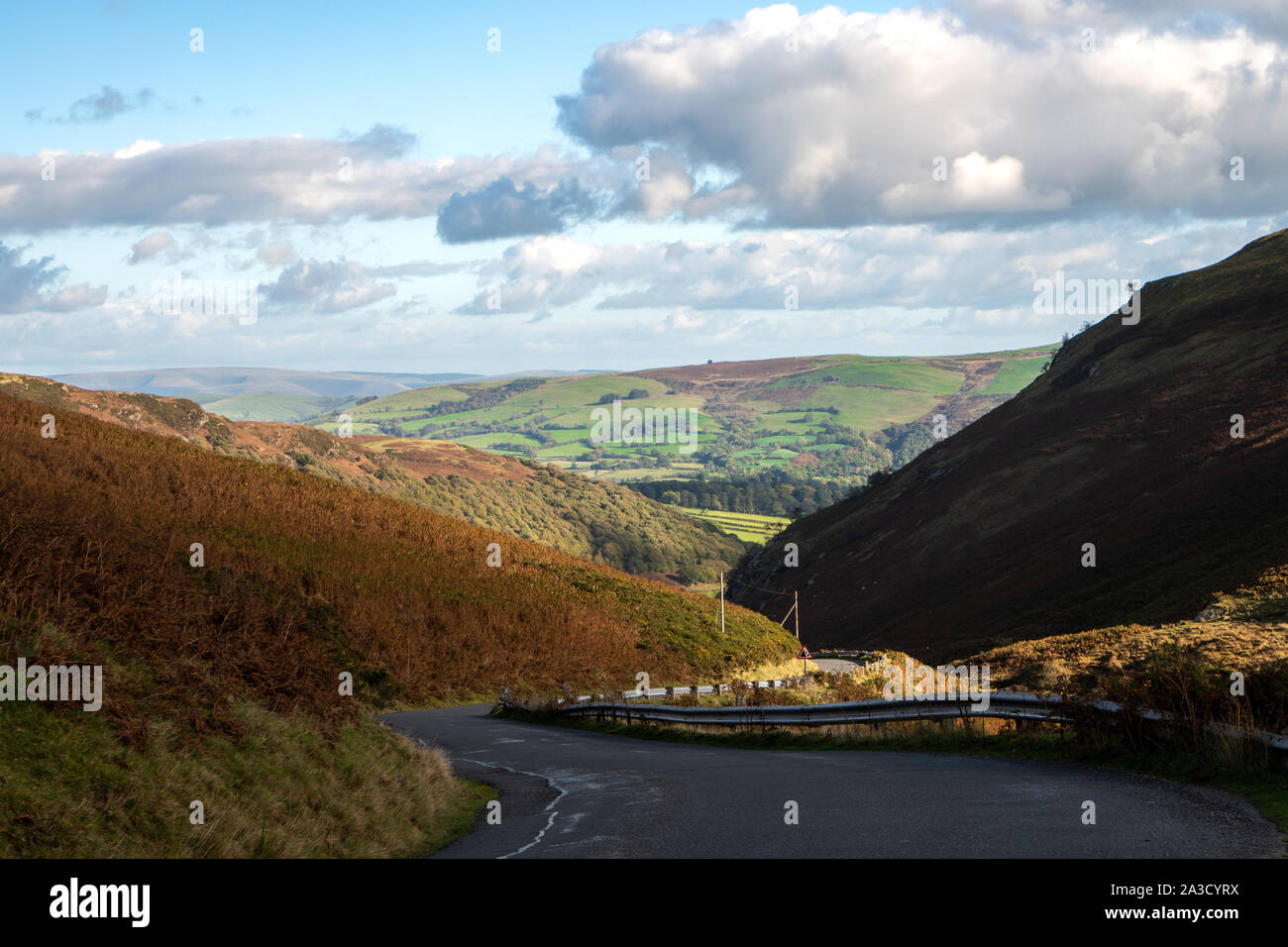 Country road winding through English valley Stock Photo - Alamy