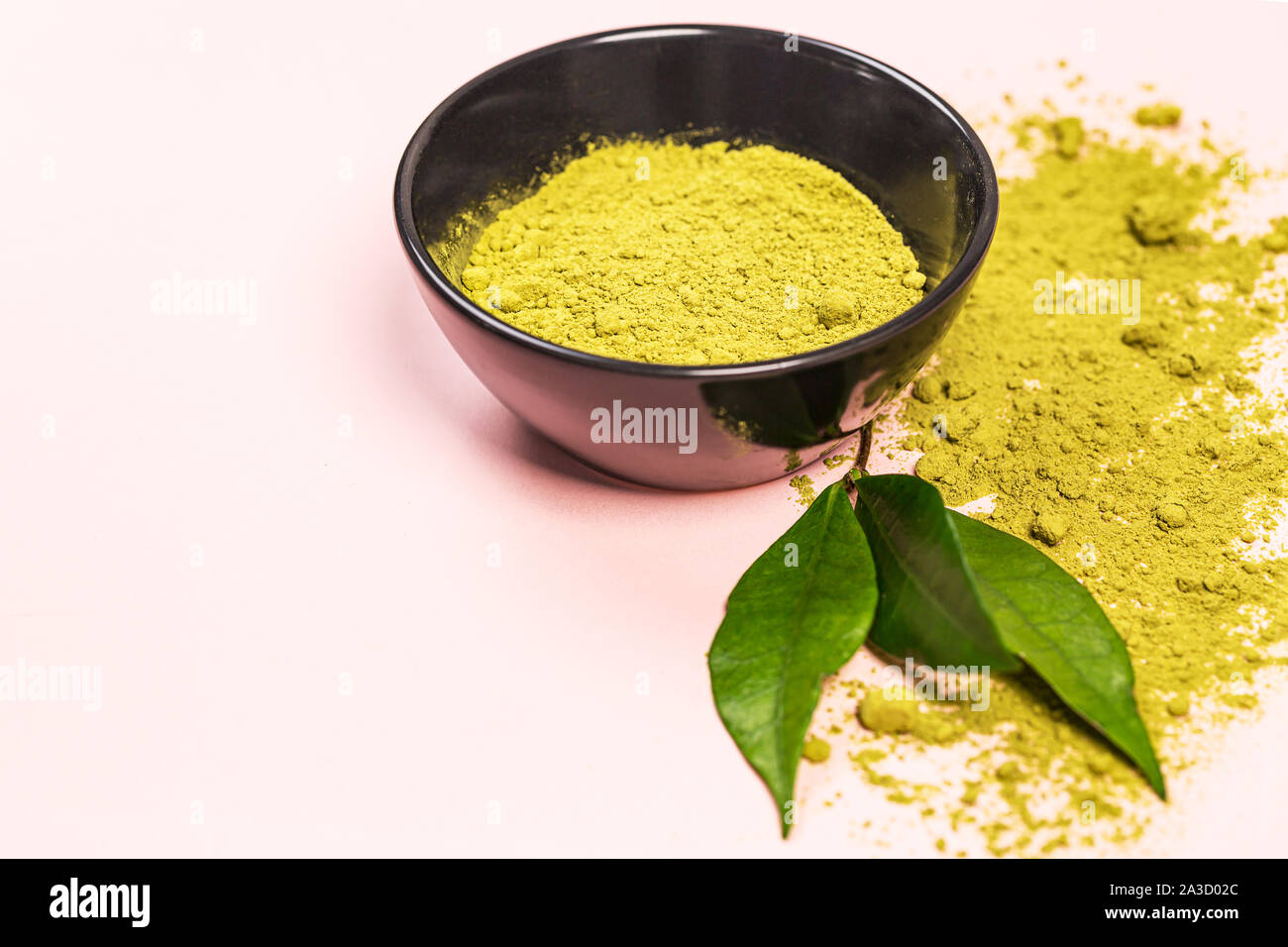 Matcha green tea powder close up on colored background Stock Photo - Alamy