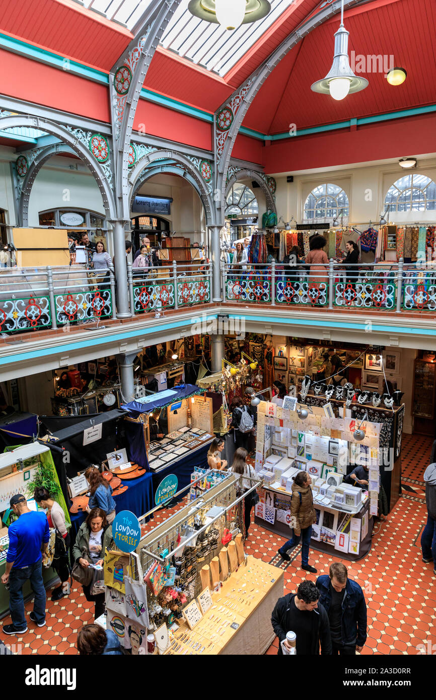 People and tourists shopping at stalls in the historic Victorian indoor ...
