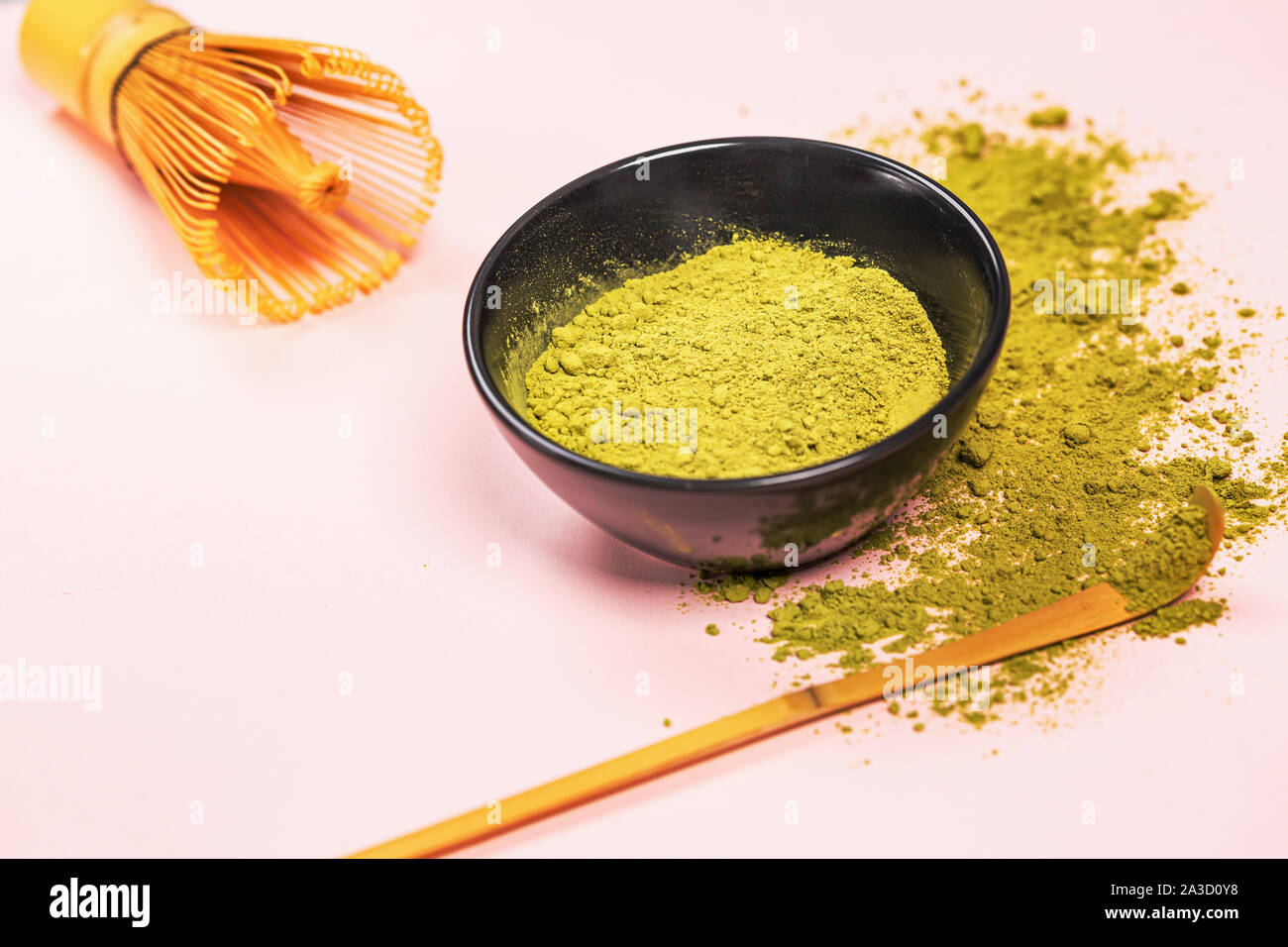 Matcha green tea powder close up on colored background Stock Photo - Alamy