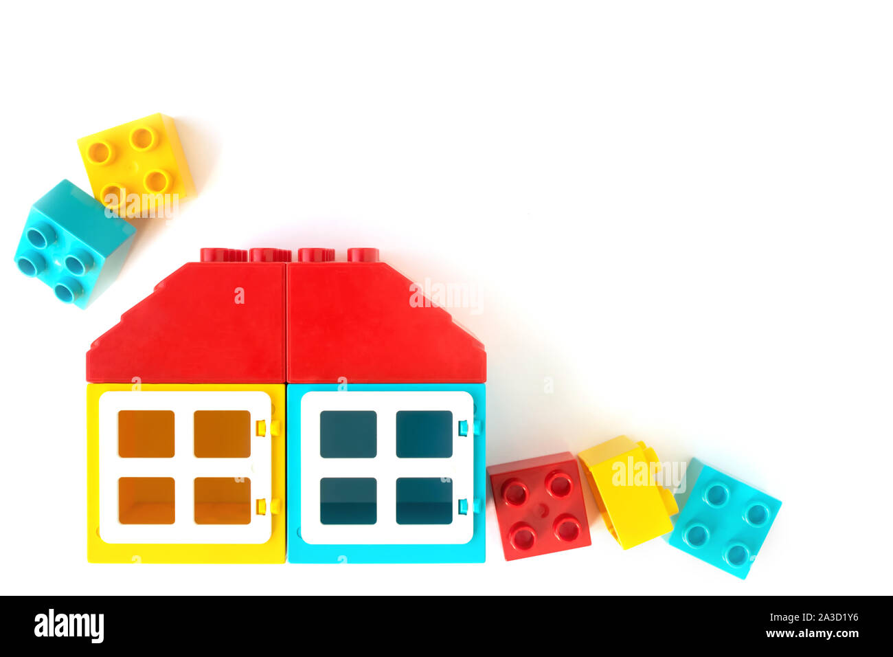 House made of colorful plastic constructor bricks on white background ...