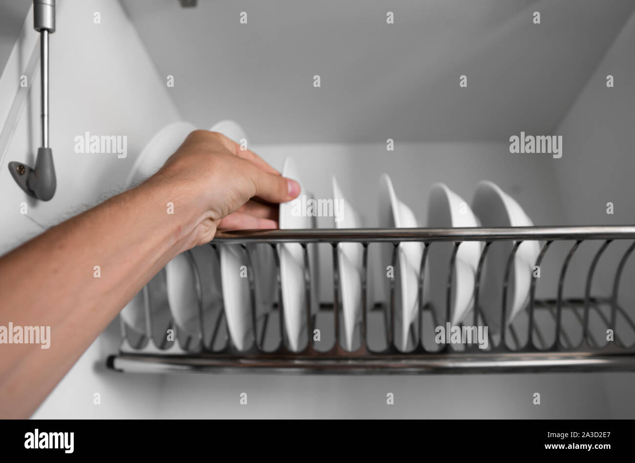 Dish drying metal rack with big nice white clean plates. Traditional ...