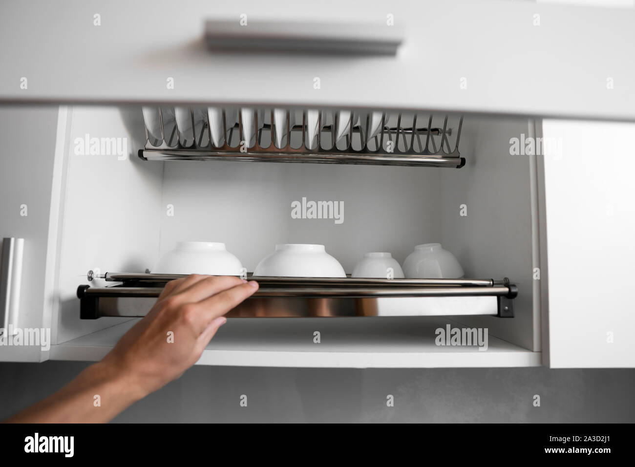 Dish drying metal rack with big nice white clean plates. Traditional ...