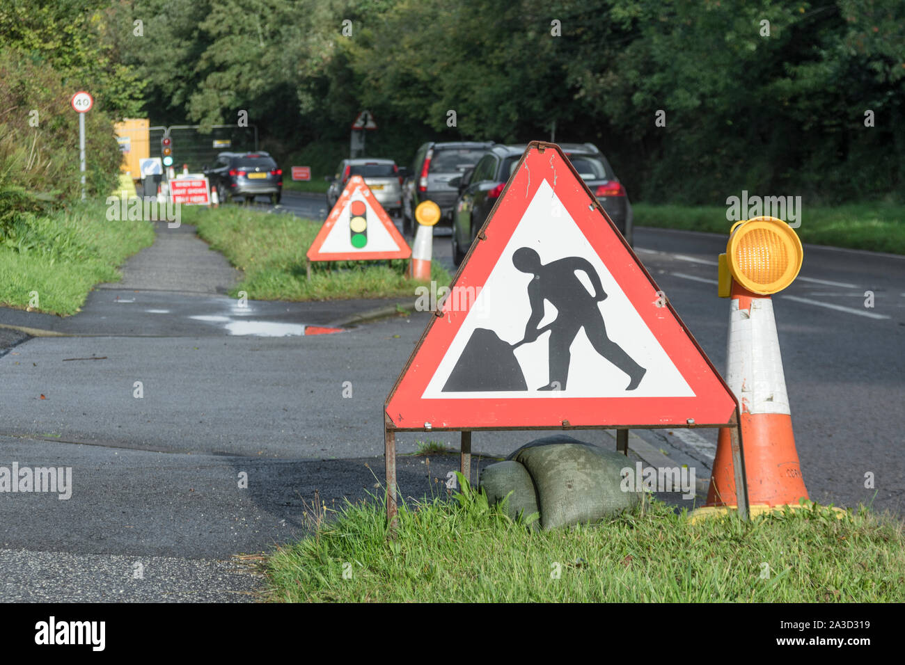 Roadworks Men at Work warning sign on roadside footpath in town of ...