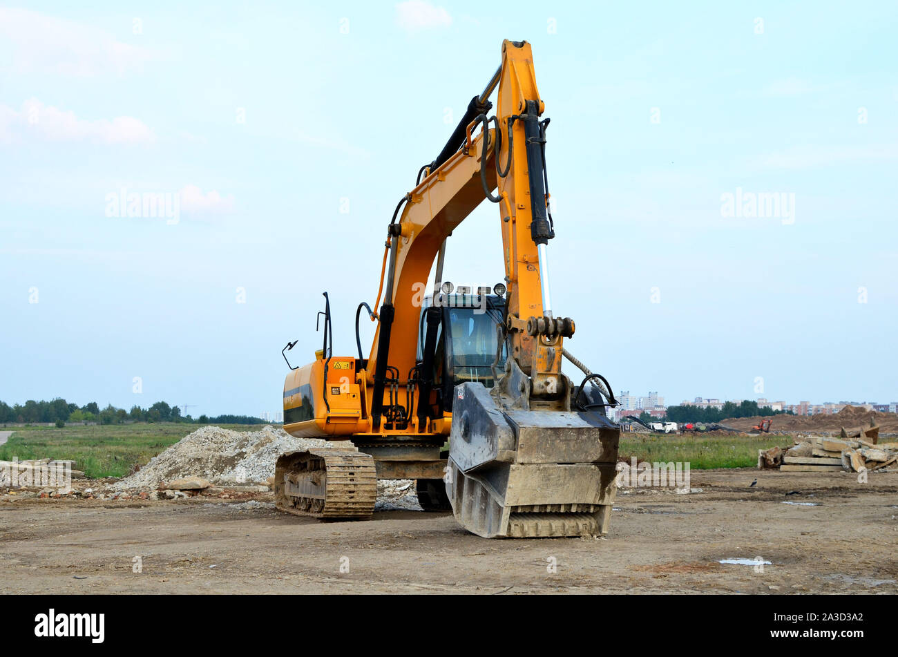 Excavator with crusher bucket for crushing concrete. Construction waste ...