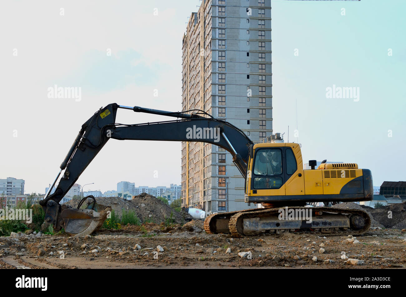The excavators on the construction site against the background of a ...