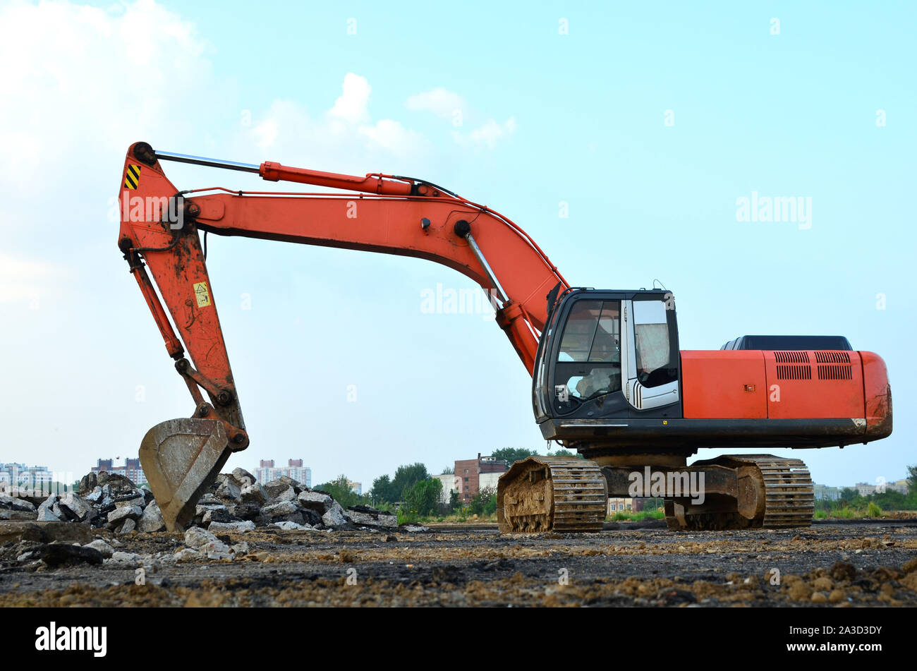 Excavator at a construction site during laying of underground pipes ...