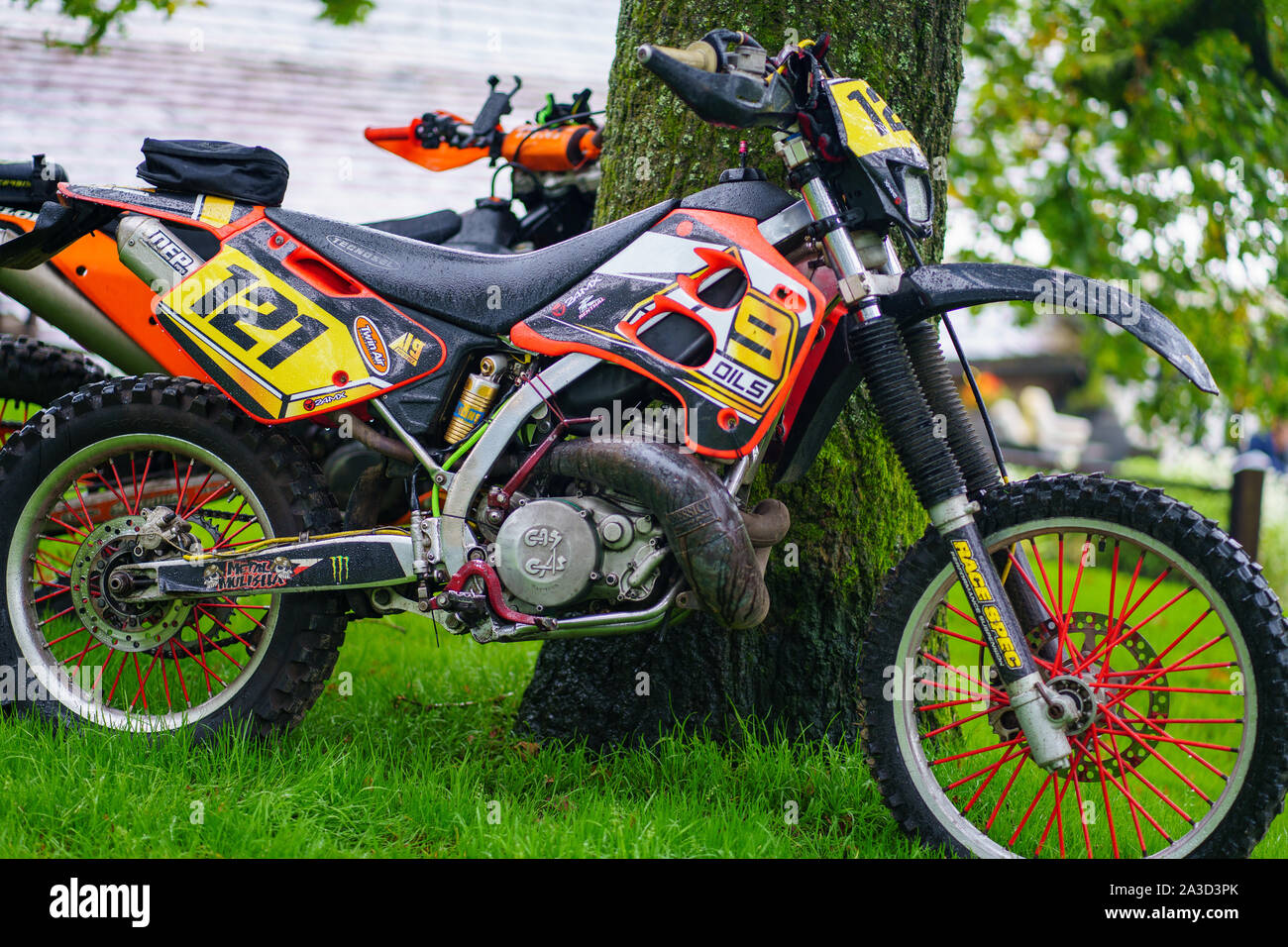 Motocross dirt bike on grass backdrop Stock Photo - Alamy