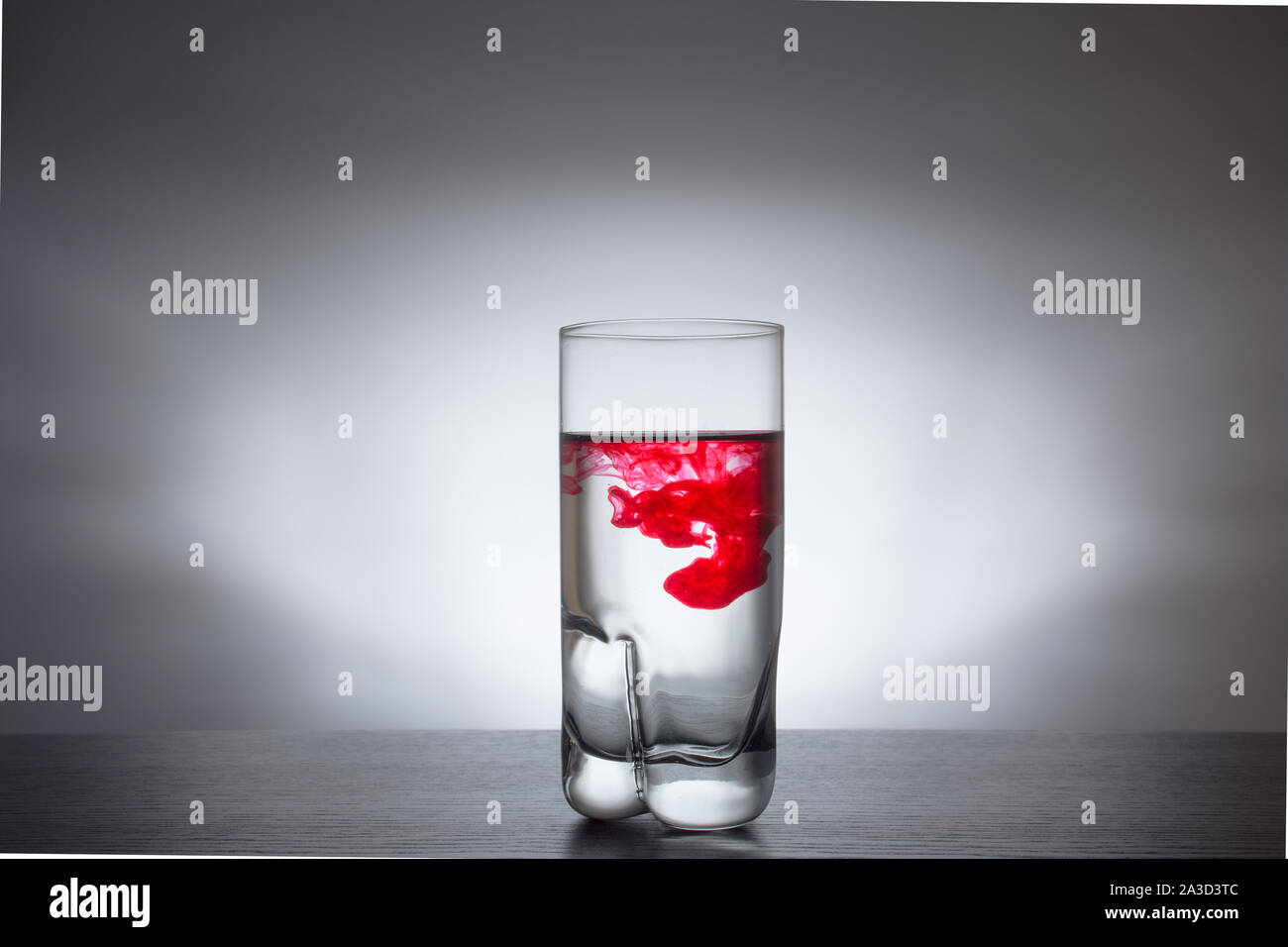 Ink diffusing in a glass of water Stock Photo - Alamy