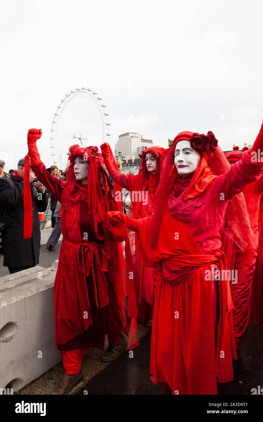 People in red robes representring the species lost to climate change ...