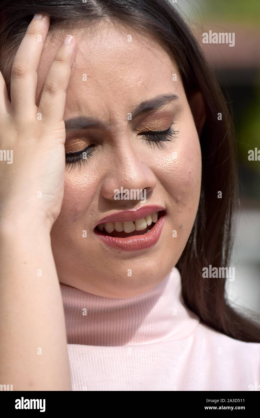 An Asian Female With Headache Stock Photo - Alamy