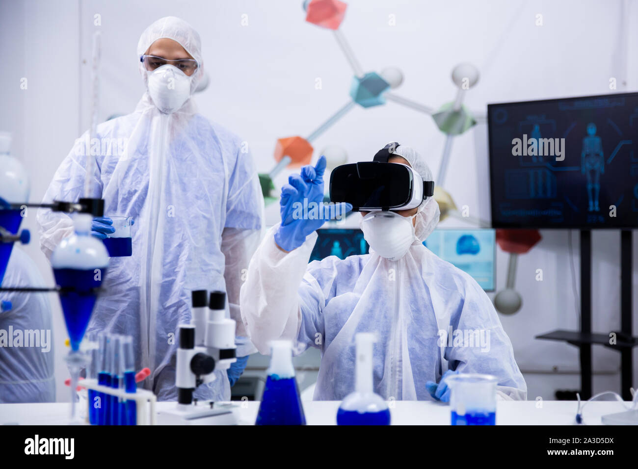 Female scientist working with virtual reality goggles in research ...