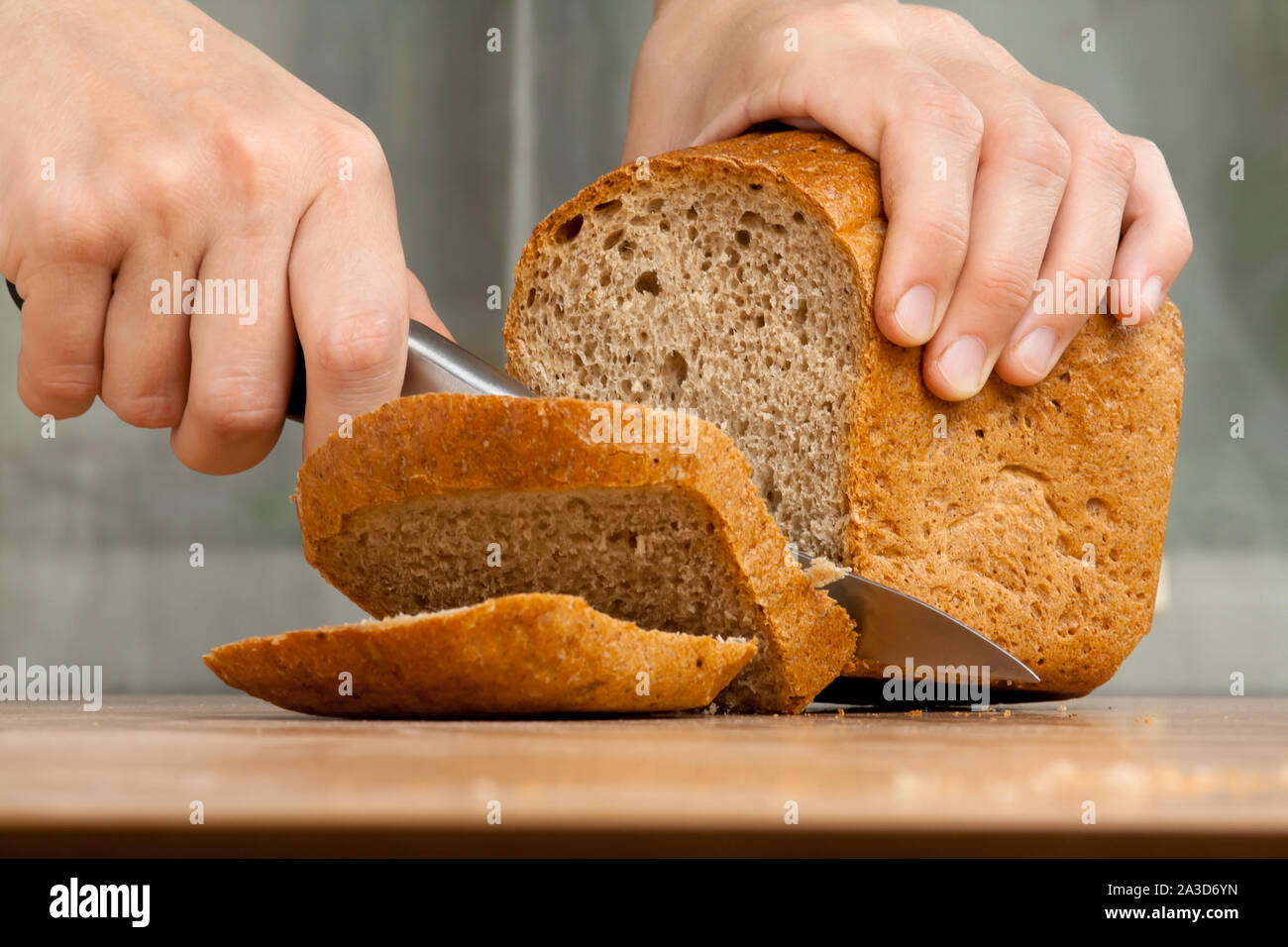 Woman slicing fresh bread hi-res stock photography and images - Alamy