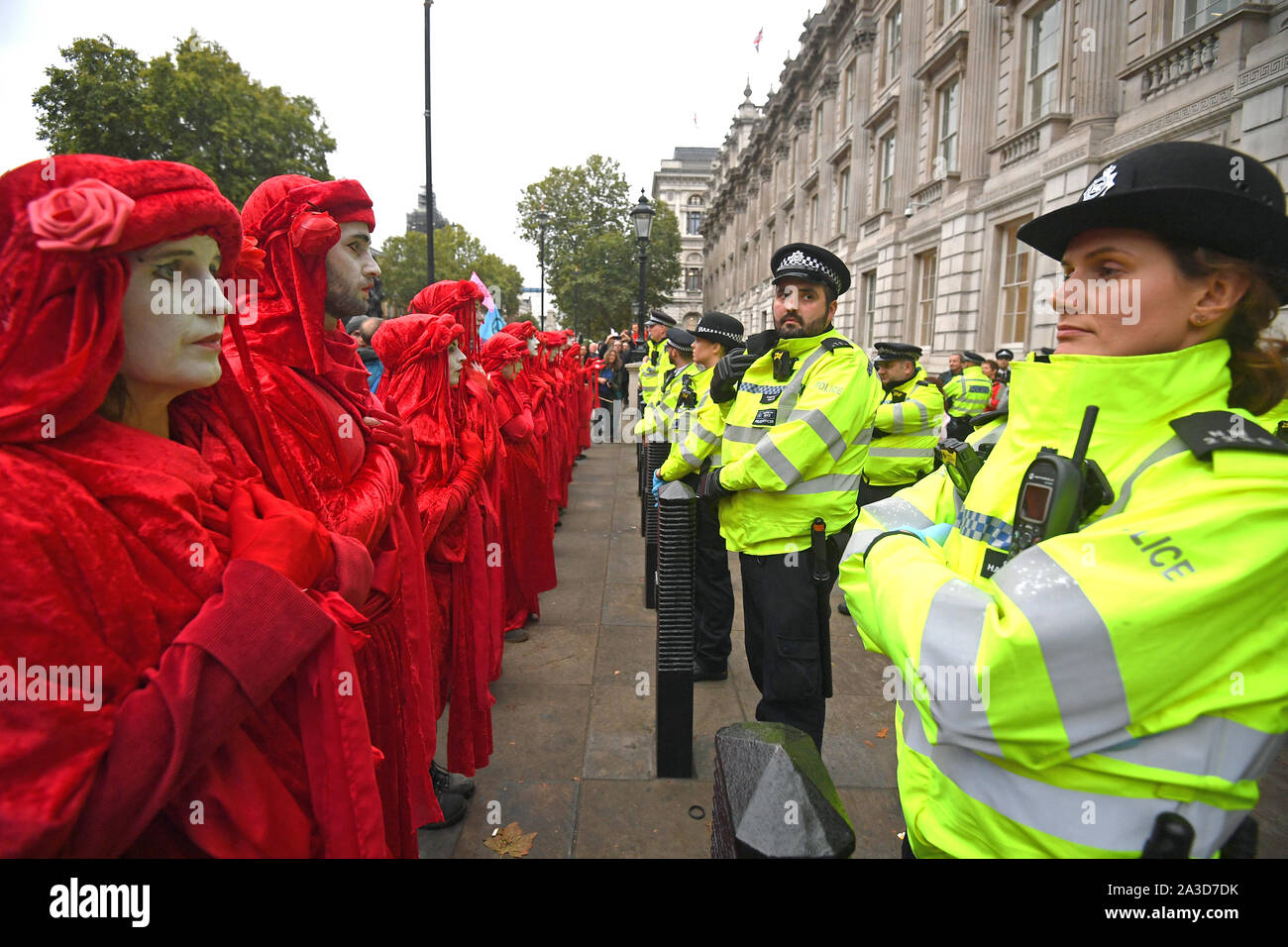 Protesters, dubbed the Red Rebels, outside the Cabinet Office on ...