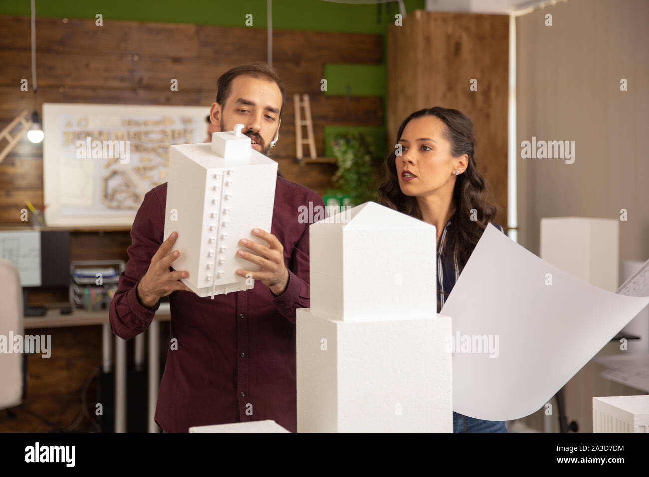 Creative designers and architects working with 3D model designs in ...