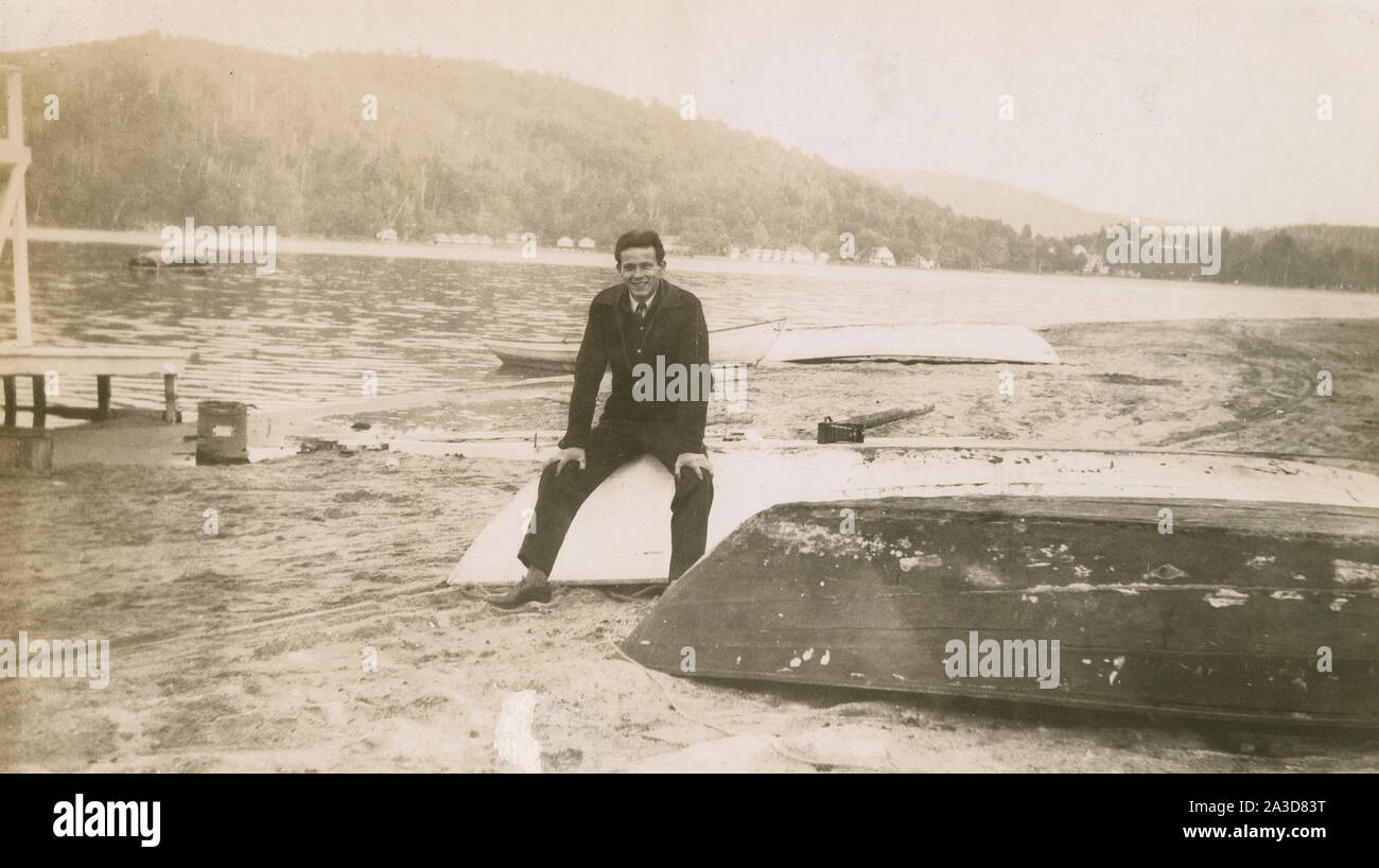Antique October 12, 1945 photograph, man sitting on rowboats on the ...