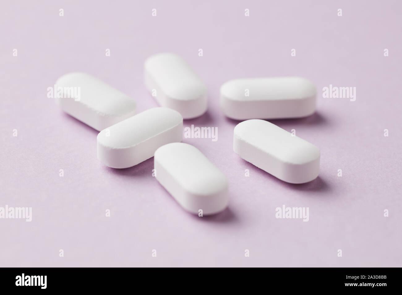 Magnesium with Vitamin B6 Tablets on pink paper background. Dietary ...