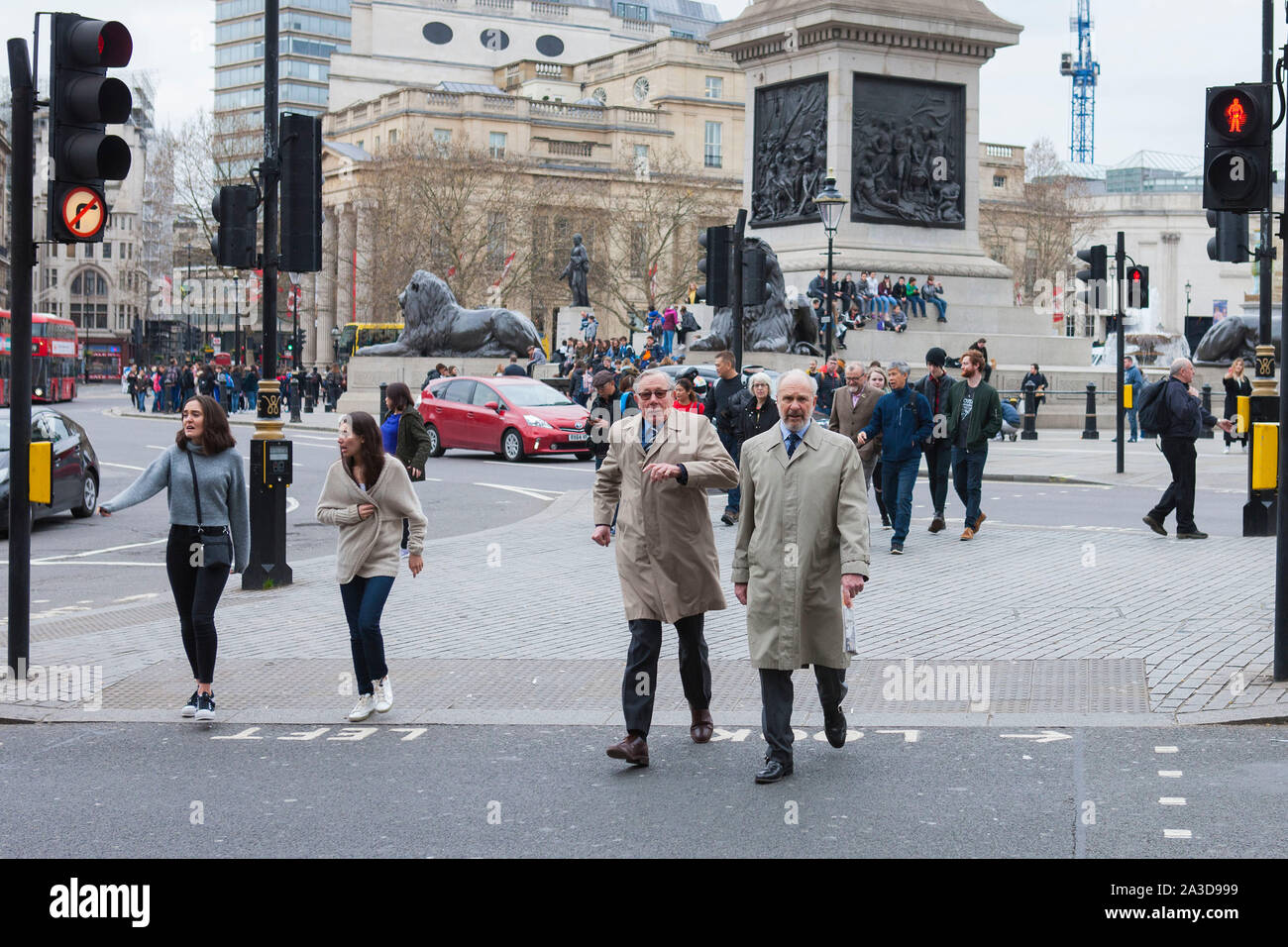 two business men cross the zebra crossing near trafalgar square, London ...