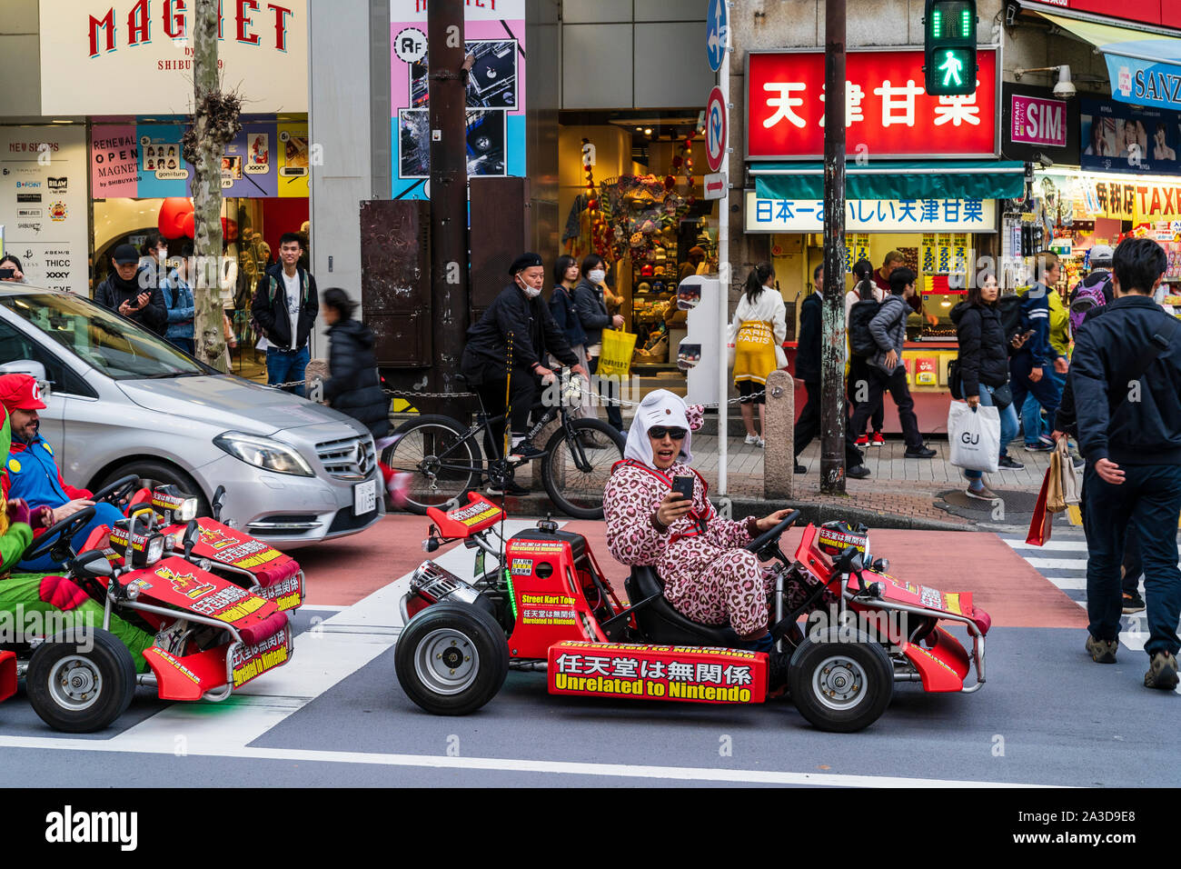 Tokyo, Shibuya crossing. Go karting Mario Karts with Caucasians dressed ...