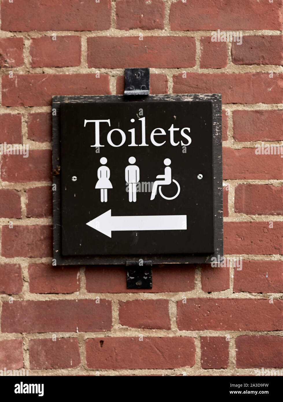 Toilet sign on the brick wall. Close up Stock Photo - Alamy