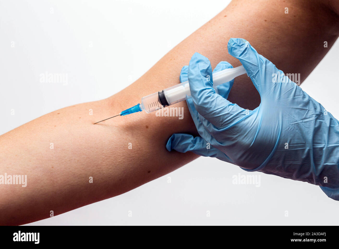 Doctor or nurse giving vaccine injection in arm to a patiend isolated ...