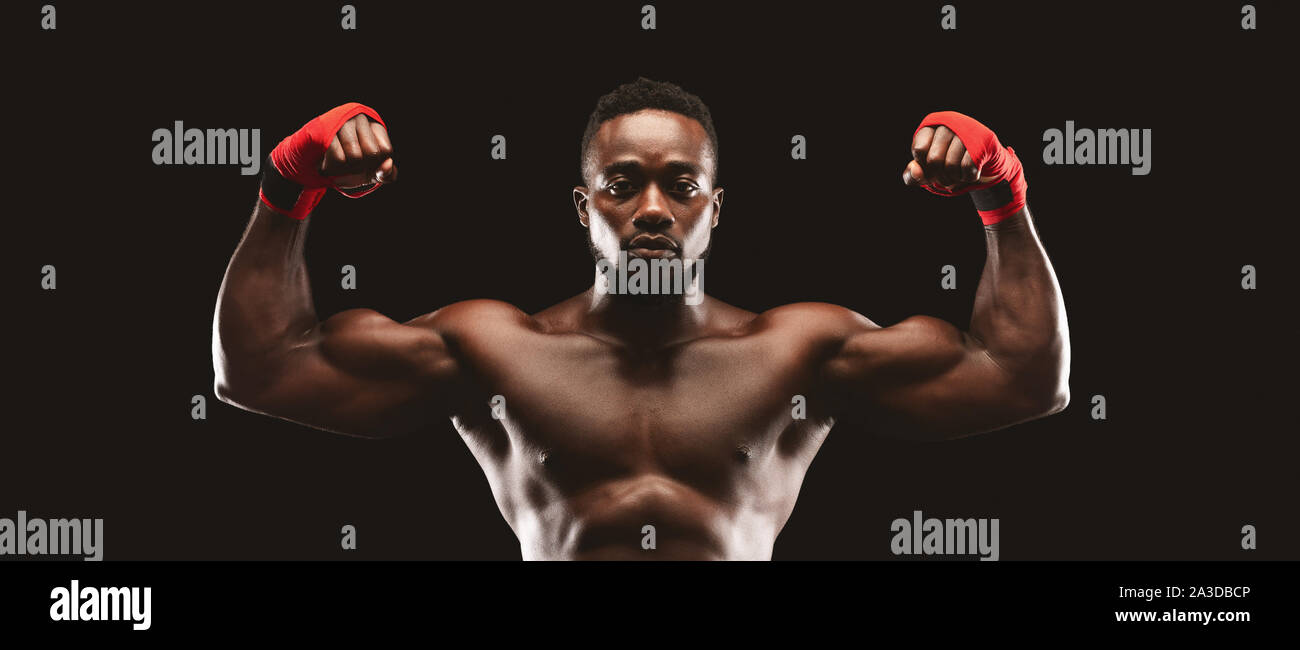 Muscular handsome kickboxer demonstrating his strong biceps Stock Photo ...