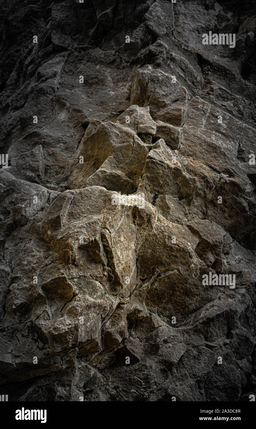 Steep rocky cliff with warm accent Stock Photo - Alamy